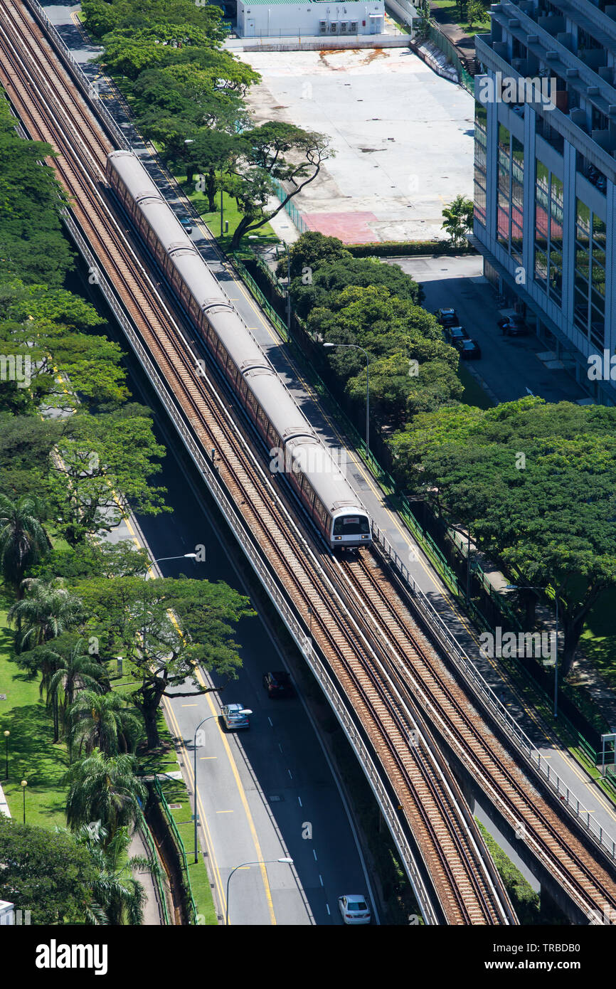 Aerial view of modern train traveling on the railroad managed by SMRT ...