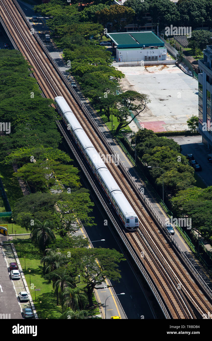 Aerial view of modern train traveling on the railroad managed by SMRT ...