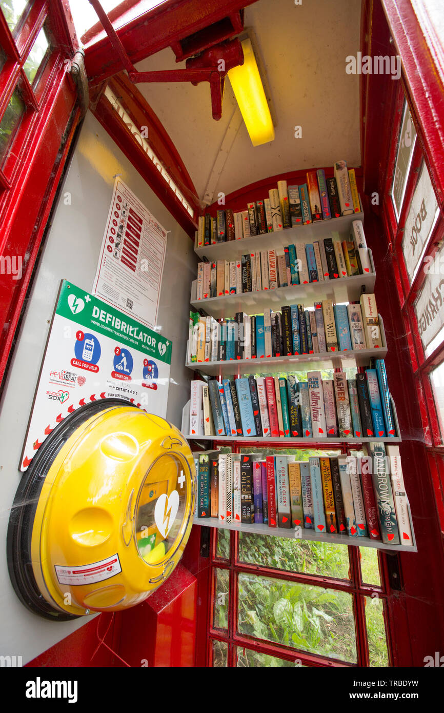 A red telephone box in rural Dorset that has been used as a book ...