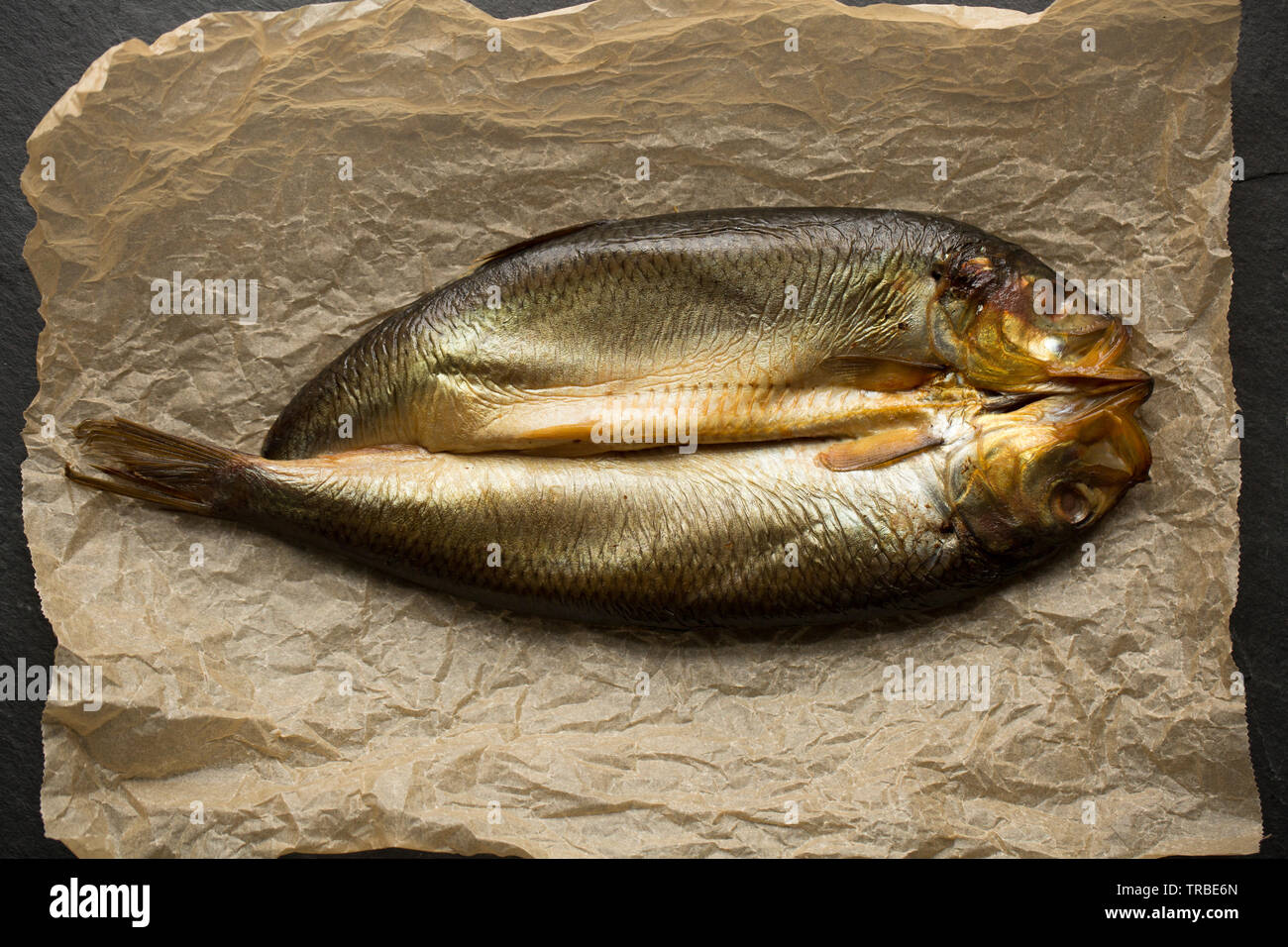 A single herring, Clupea harengus, that have been split and cold smoked ...