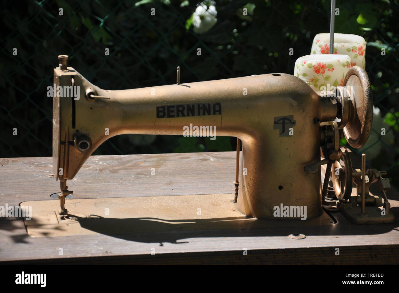 Old gold-colored sewing machine Stock Photo - Alamy