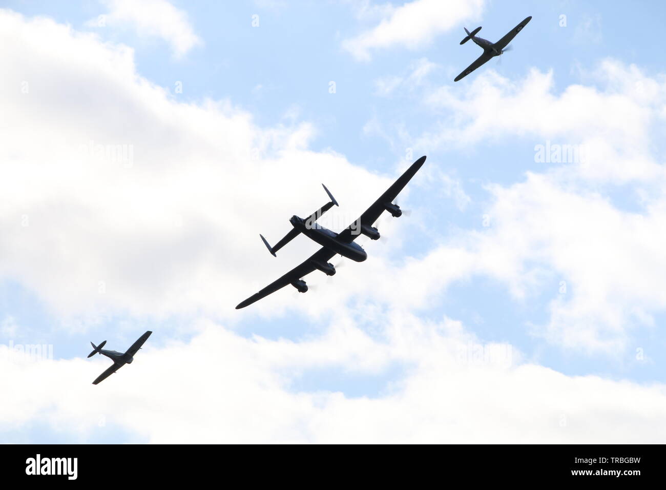 Lancaster Bomber , 2 hurricanes & a Spitfire flying formation Stock ...