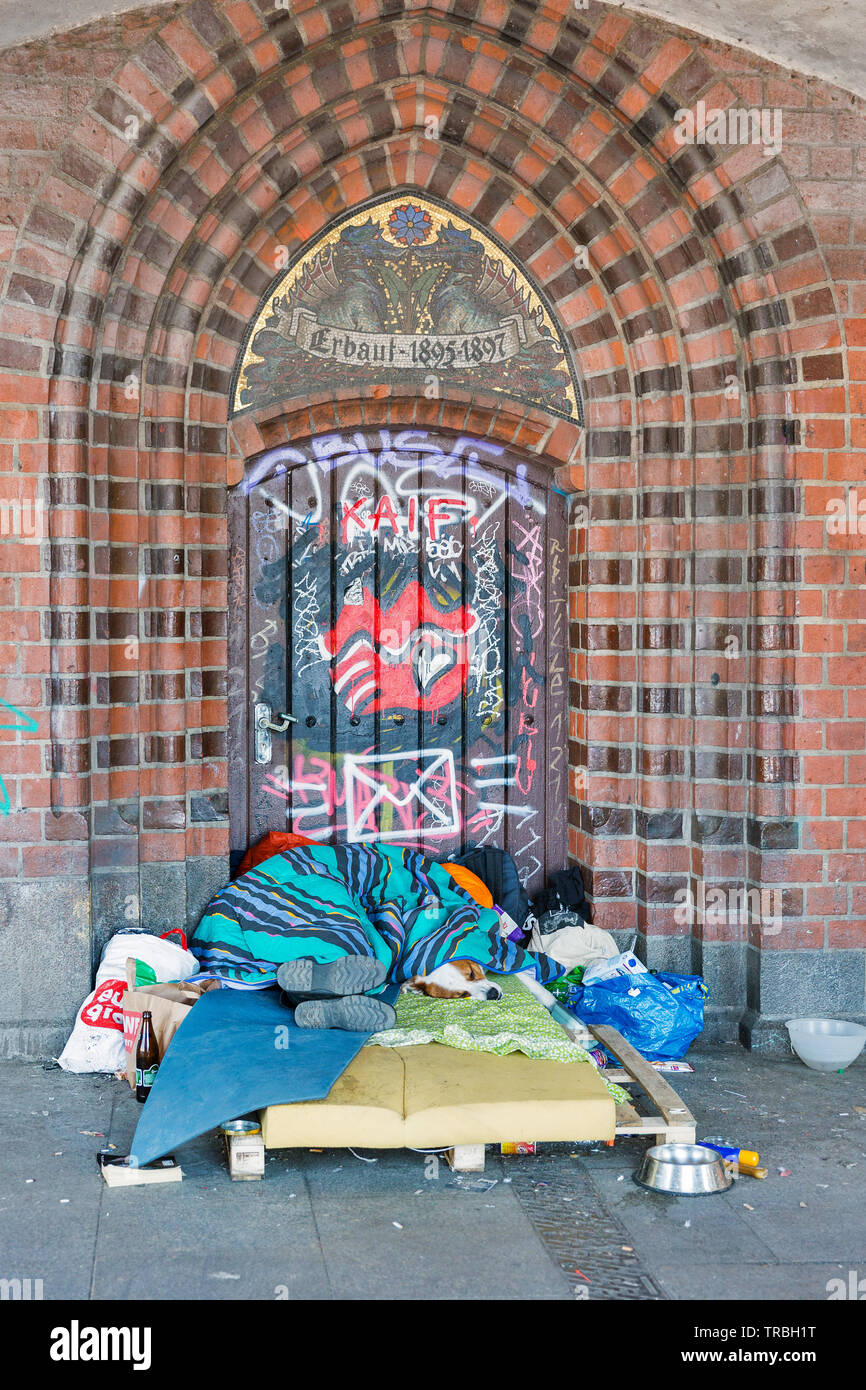BERLIN, GERMANY - APRIL 18, 2019: A homeless man asleep over a ...