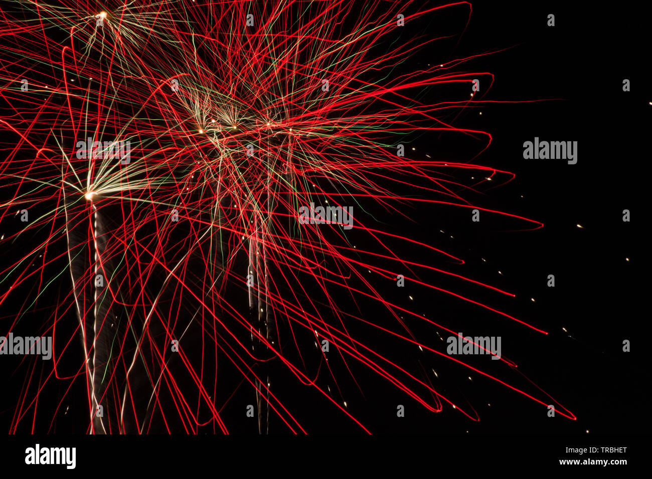 Red rockets explode in the night sky Stock Photo - Alamy