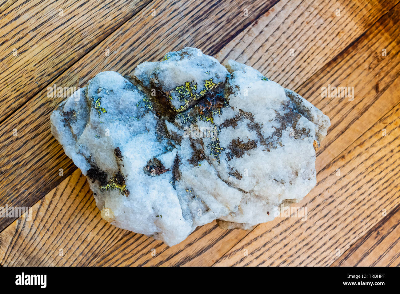 Colorful rainbow stone on rustic wood background Stock Photo - Alamy