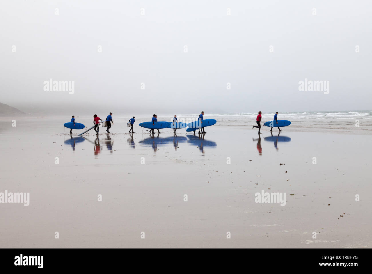 Newgale Beach in Pembrokshire on a grey, misty day. Young students ...