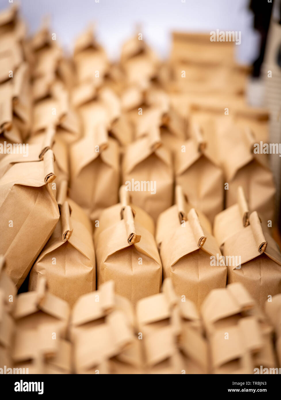 Many little brown paper bags of coffee Stock Photo - Alamy