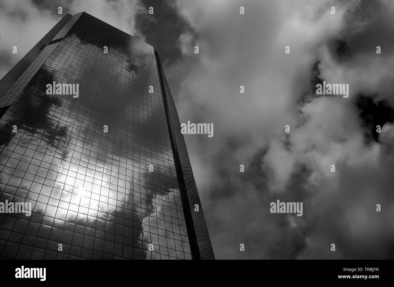 Skyscraper glass facade with reflection of sky and clouds. Concept of ...