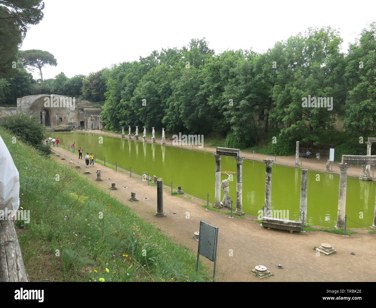Greek statues line the long Canopus pool with the Serapeum grotto at ...