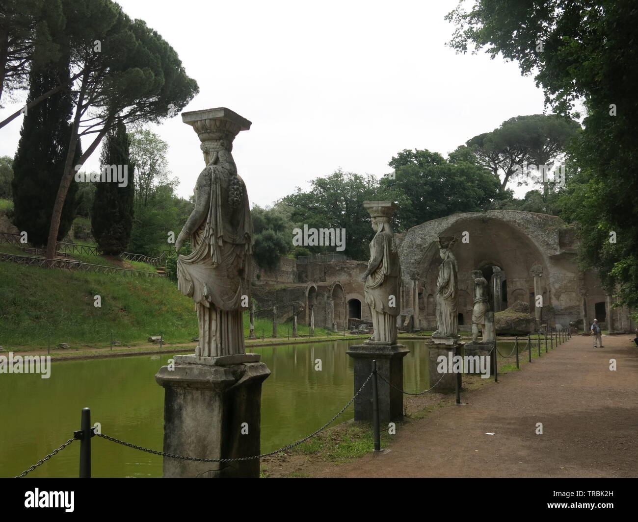 Greek statues line the long Canopus pool with the Serapeum grotto at ...