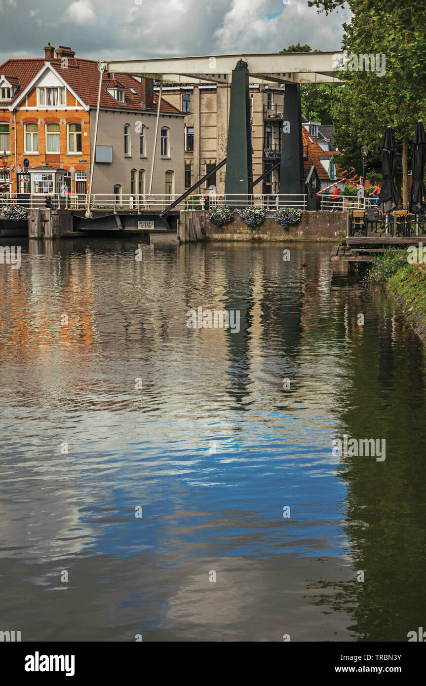 Clouds and sky reflected in canal water surface, buildings and bascule ...