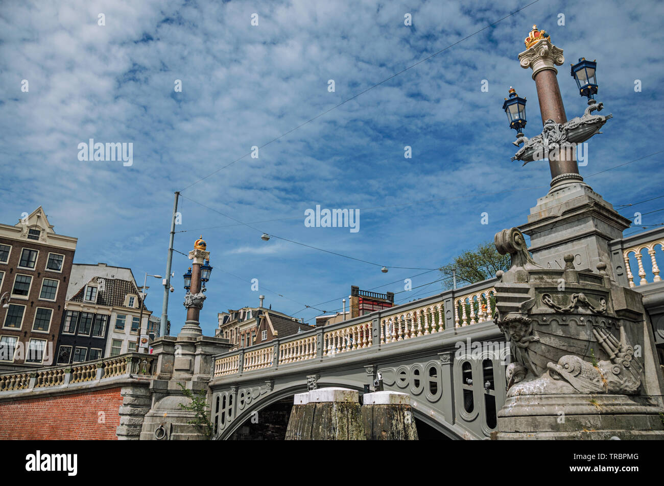 Stone bridge over canal decorated by sculpture of ship's bow in ...
