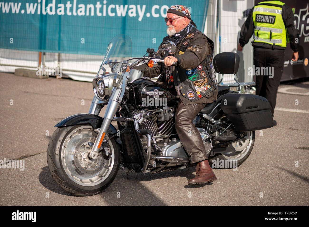Killarney Ireland Bike Fest gathering. Senior rider biker in brown ...
