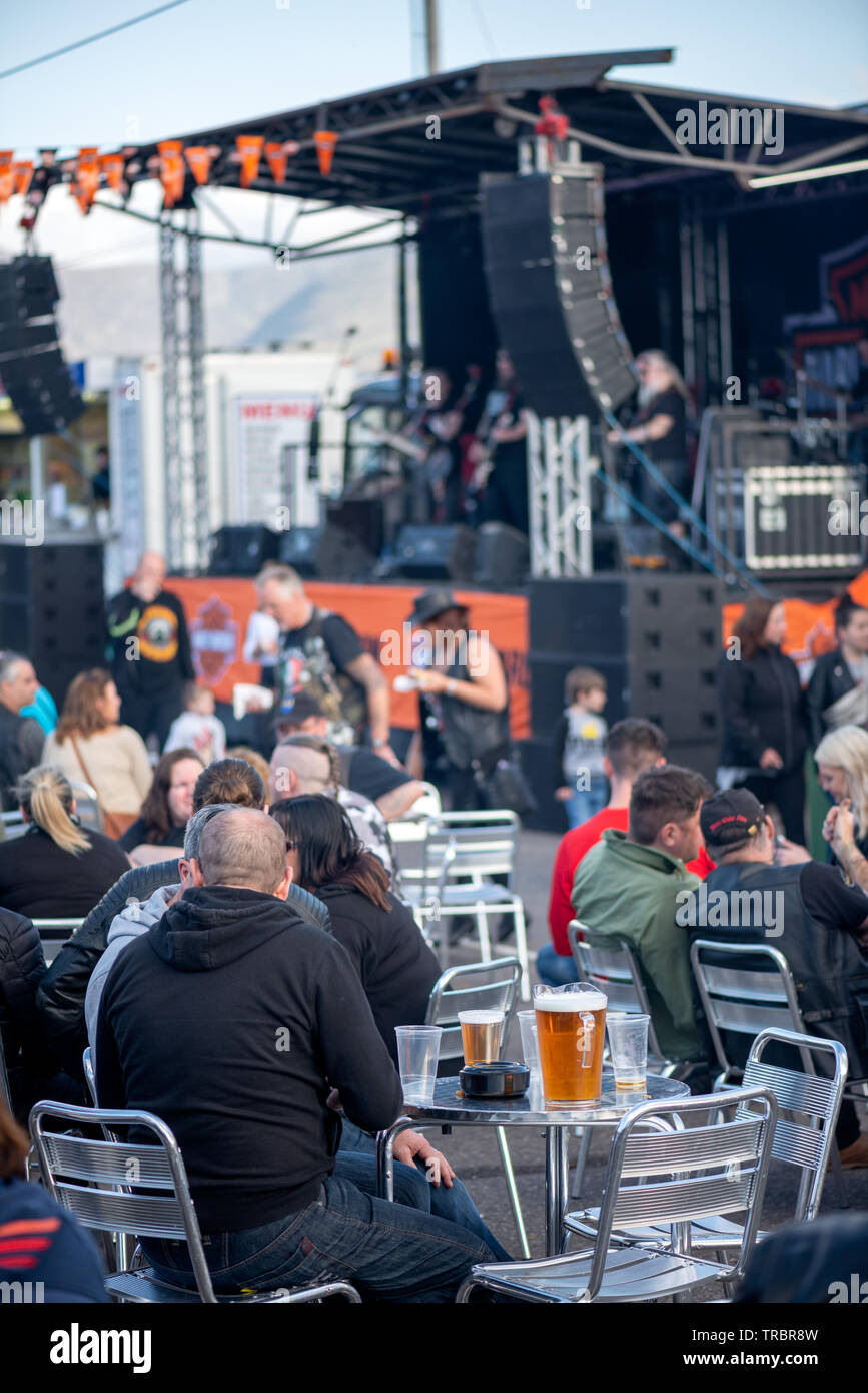 People visitors having beer at the concert stage at the Harley Davidson ...