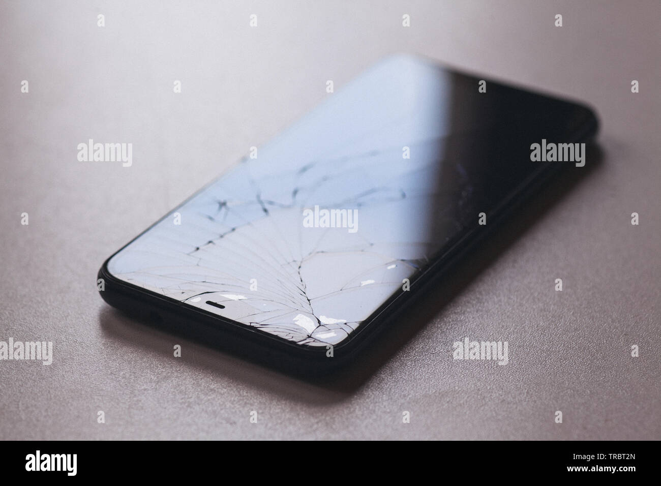 Phone with broken touch-screen screen on black table desktop Stock ...