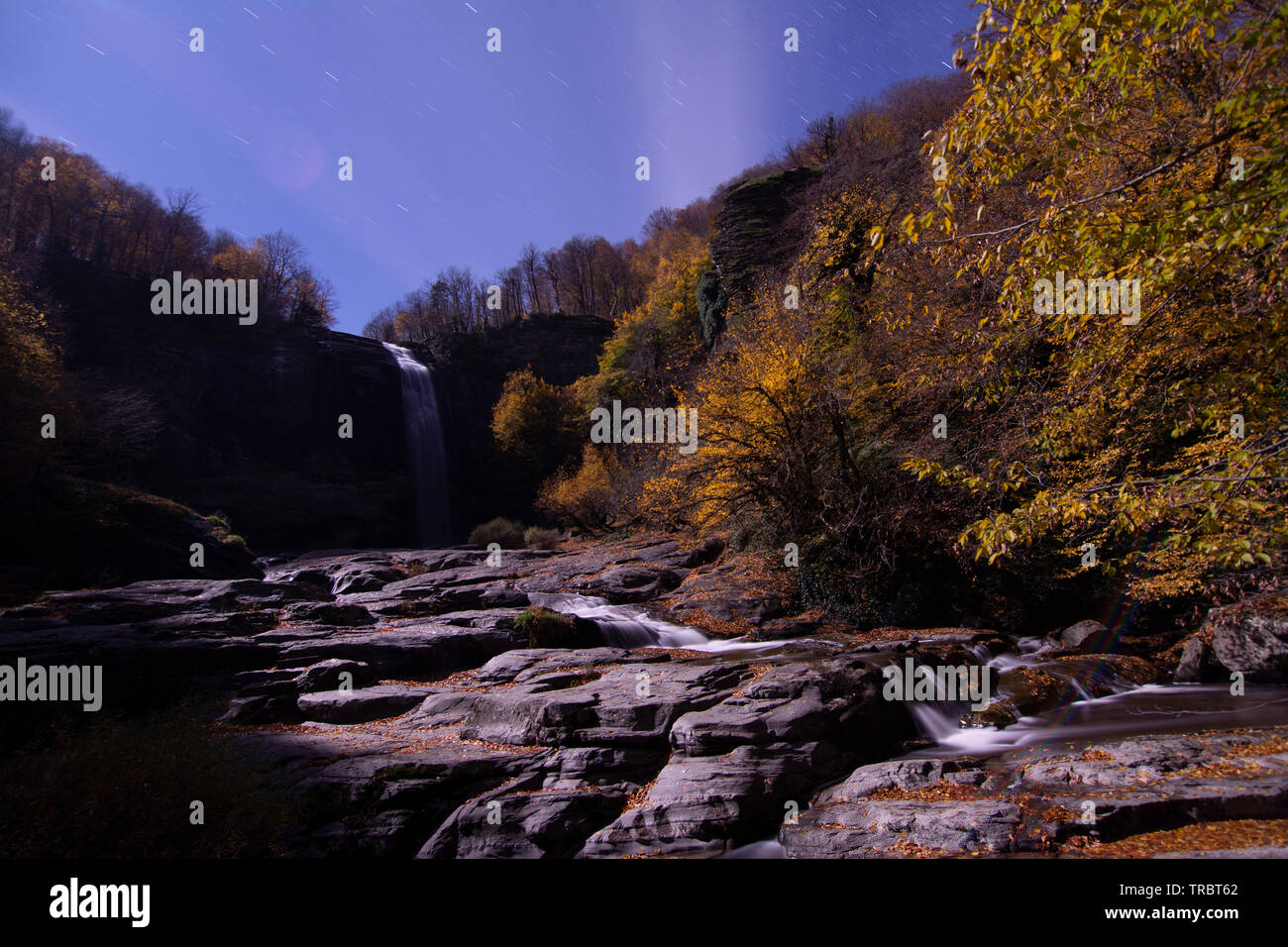 Autumn colors with waterfall and leaves Stock Photo - Alamy