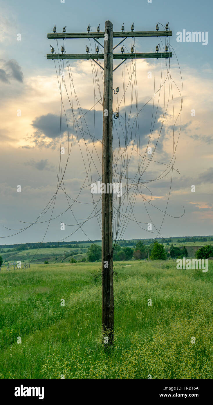 Old wooden Telegraph pole with cut electrical wires on sunset ...