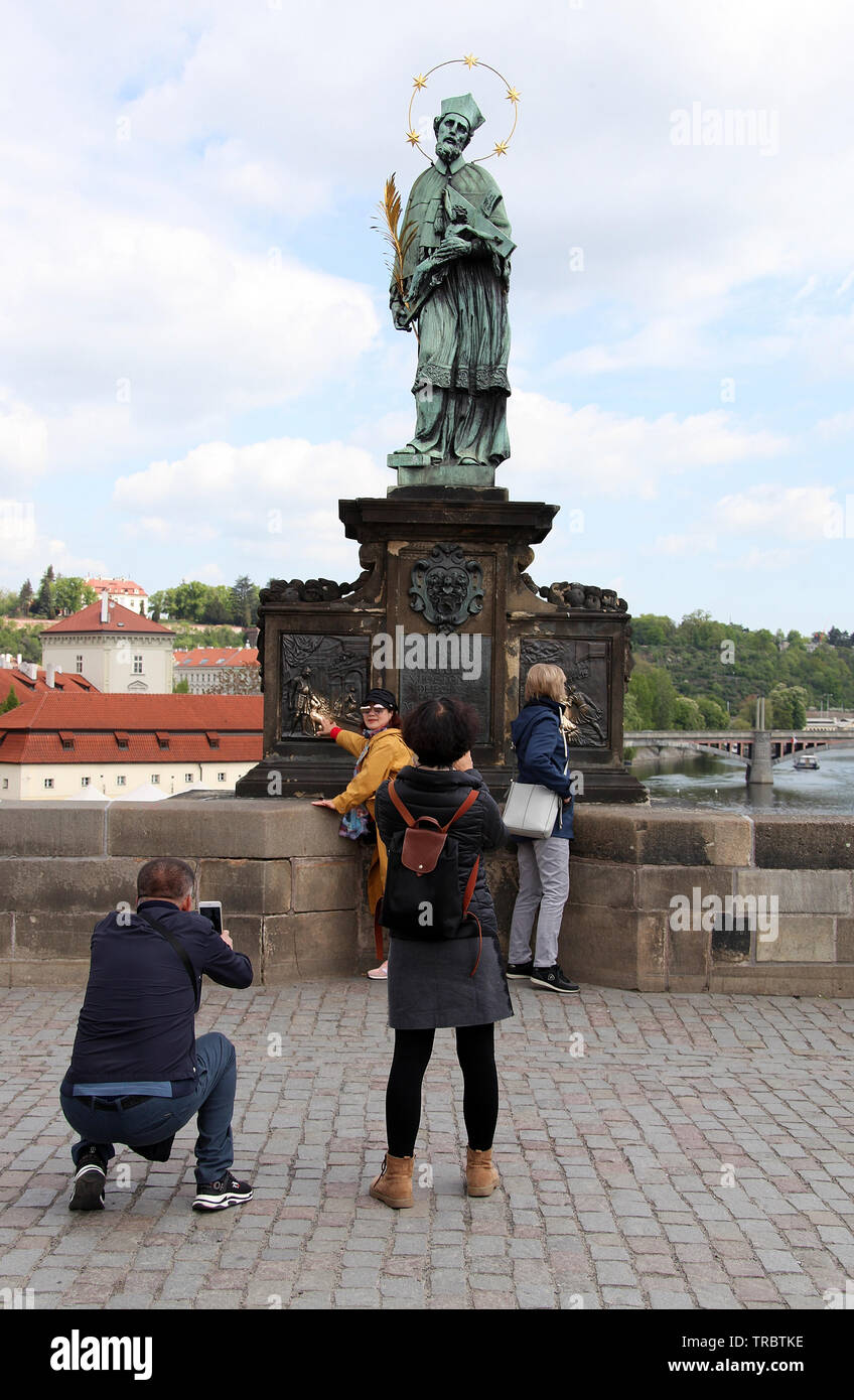 Tourists at the famous statue of Saint John of Nepomuk on the north ...