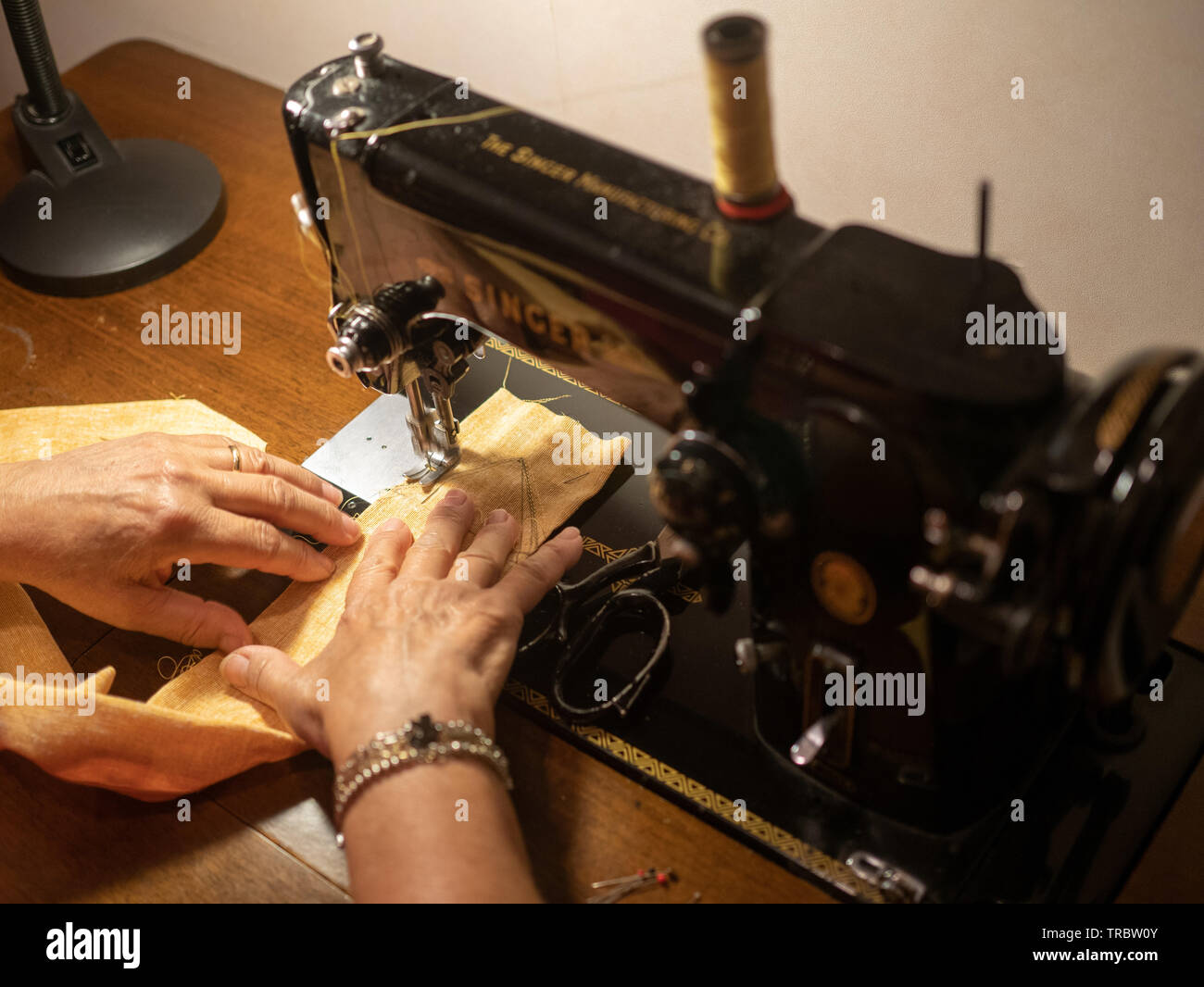 Old Woman Sawing with ancient sawing machine Stock Photo - Alamy
