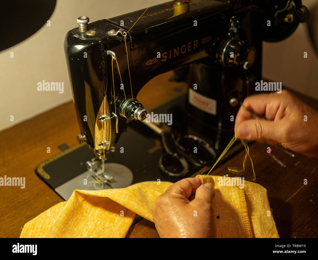 Old Woman Sawing with ancient sawing machine Stock Photo - Alamy