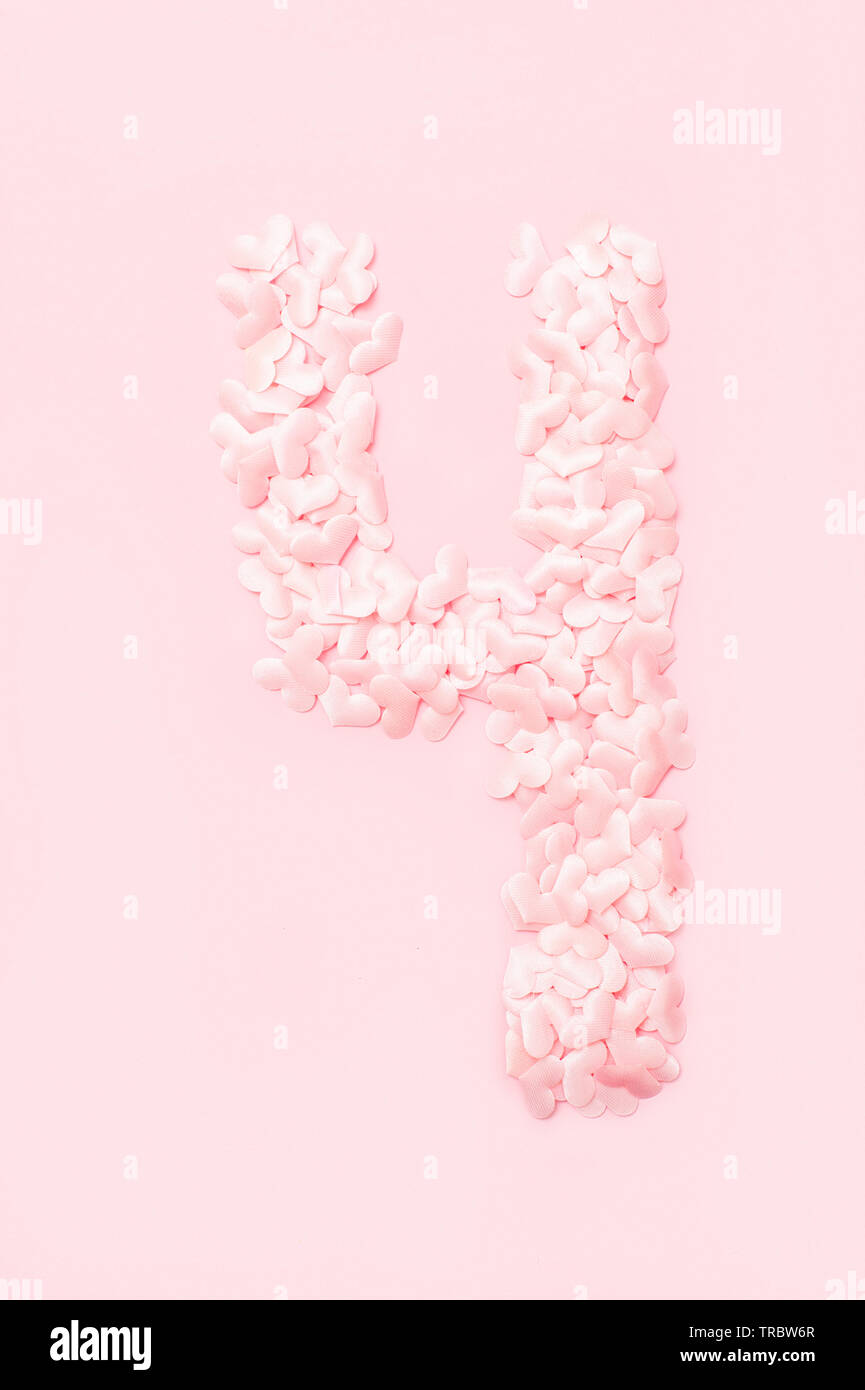 Number four collected from decorative pink hearts. Isolated on pink ...