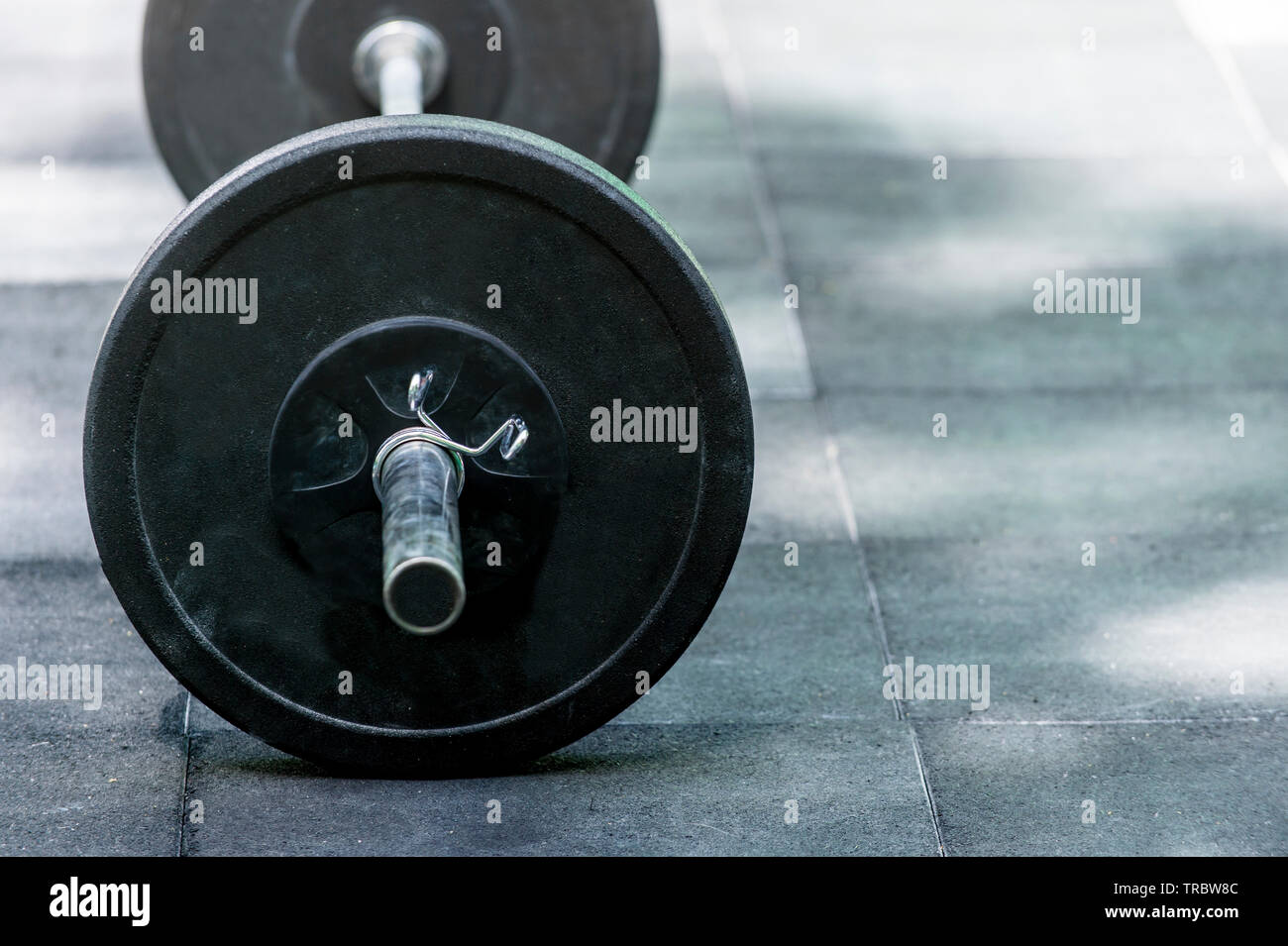 Heavy barbell on the floor of a gym studio copyspace bodybuilding ...
