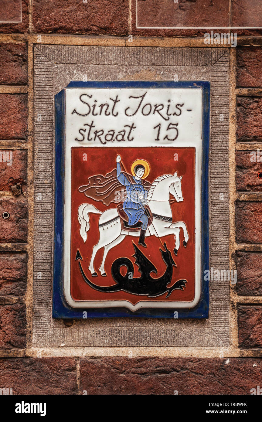 Street sign with paint of Saint George and dragon in street of s ...