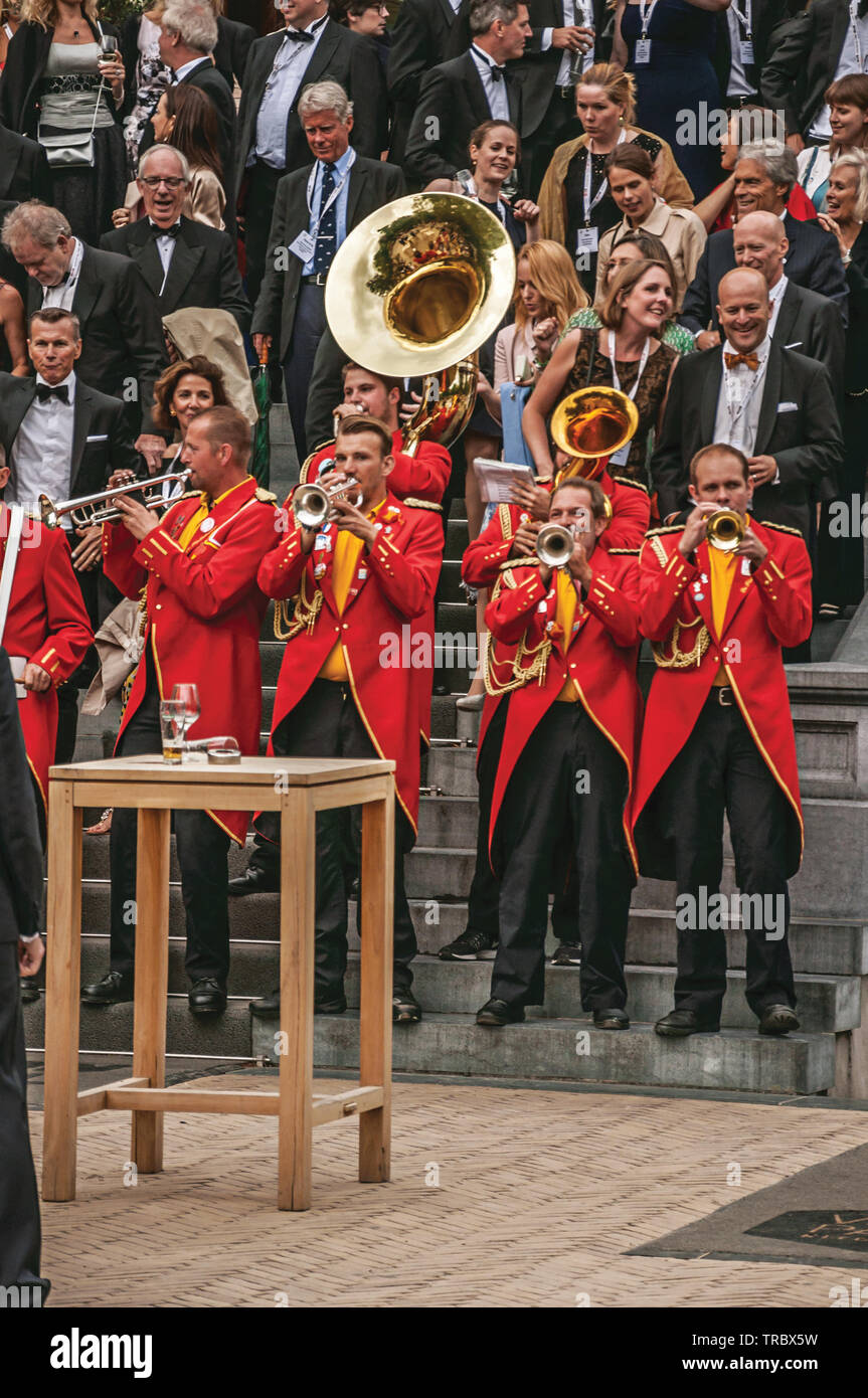 Excited musical band playing in festivity with cloudy sky at Amsterdam ...