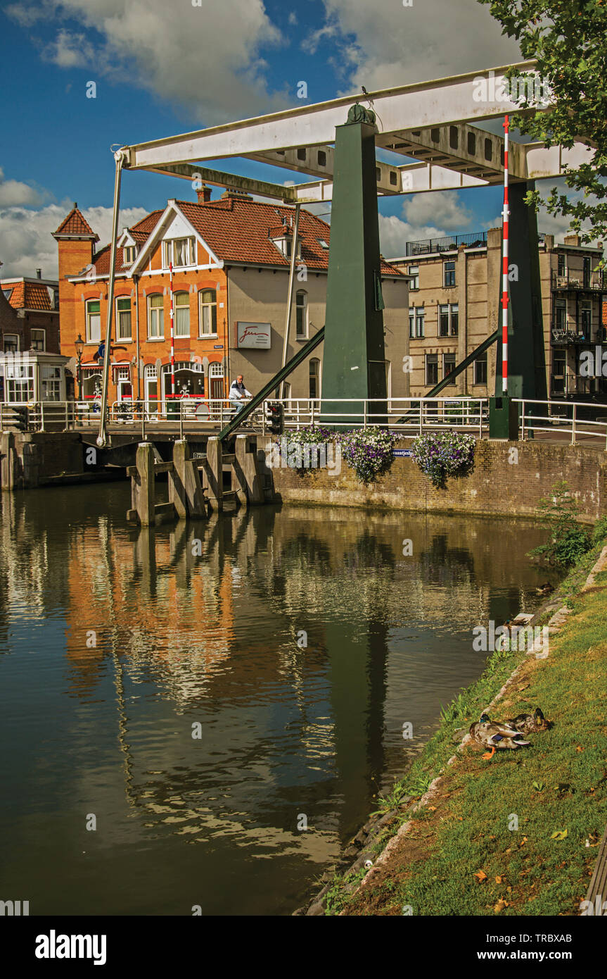 Houses and bascule bridge reflected in wide canal water surface on ...
