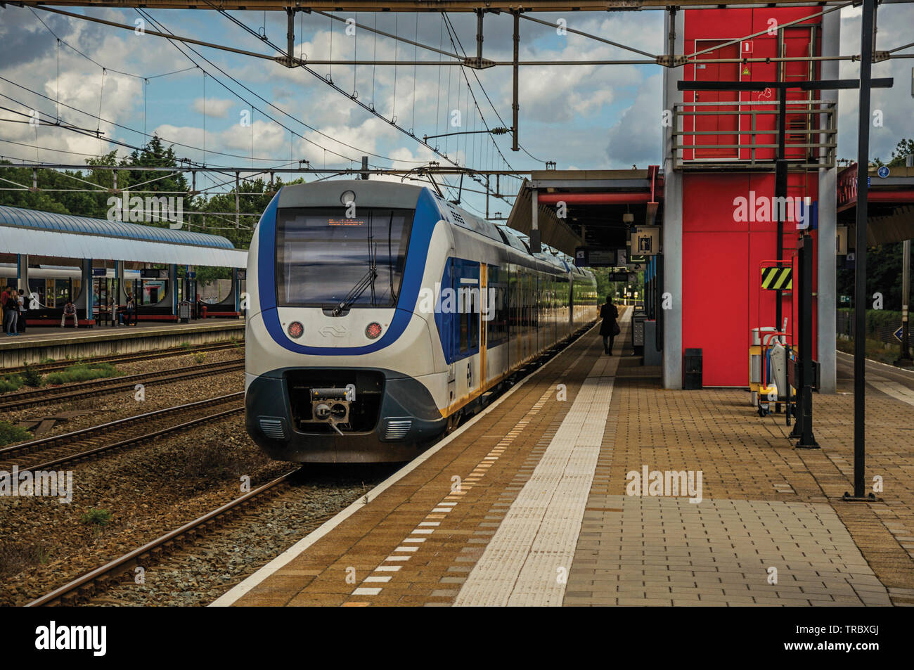 Locomotive stop on train station platform, railroad rails and blue ...