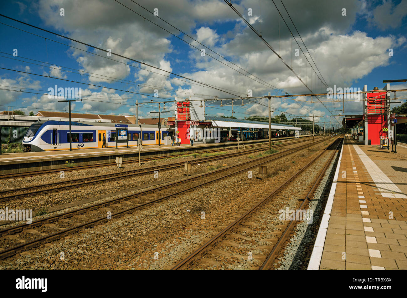 Locomotive stop on train station platform, railroad rails and blue ...