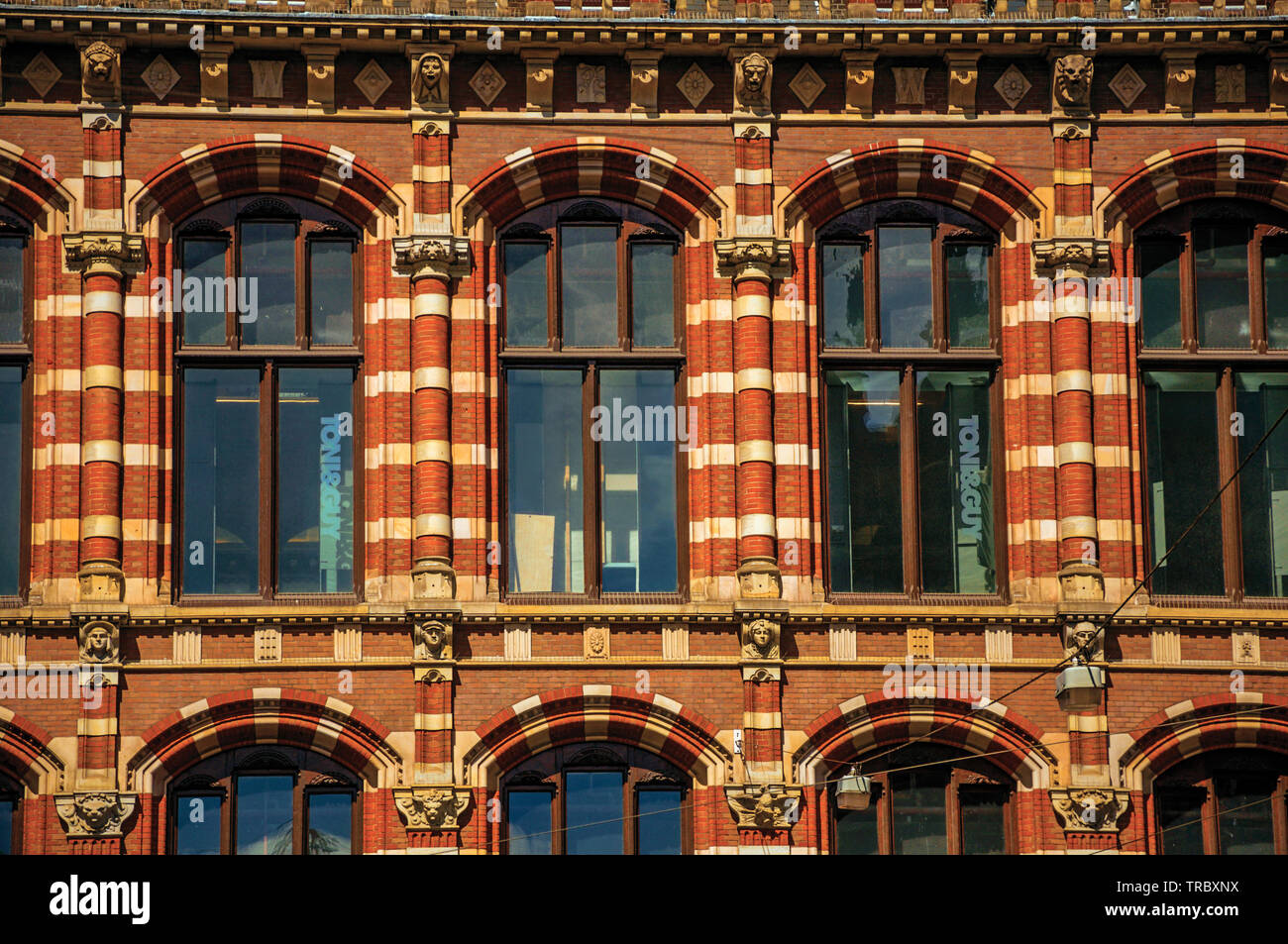 Brick facade with windows and columns in an old building of Amsterdam ...