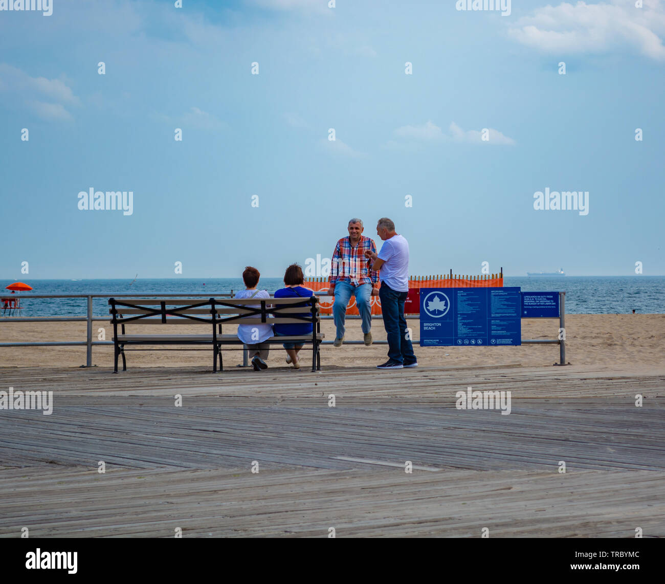 Woman sitting wooden boardwalk hi-res stock photography and images - Alamy