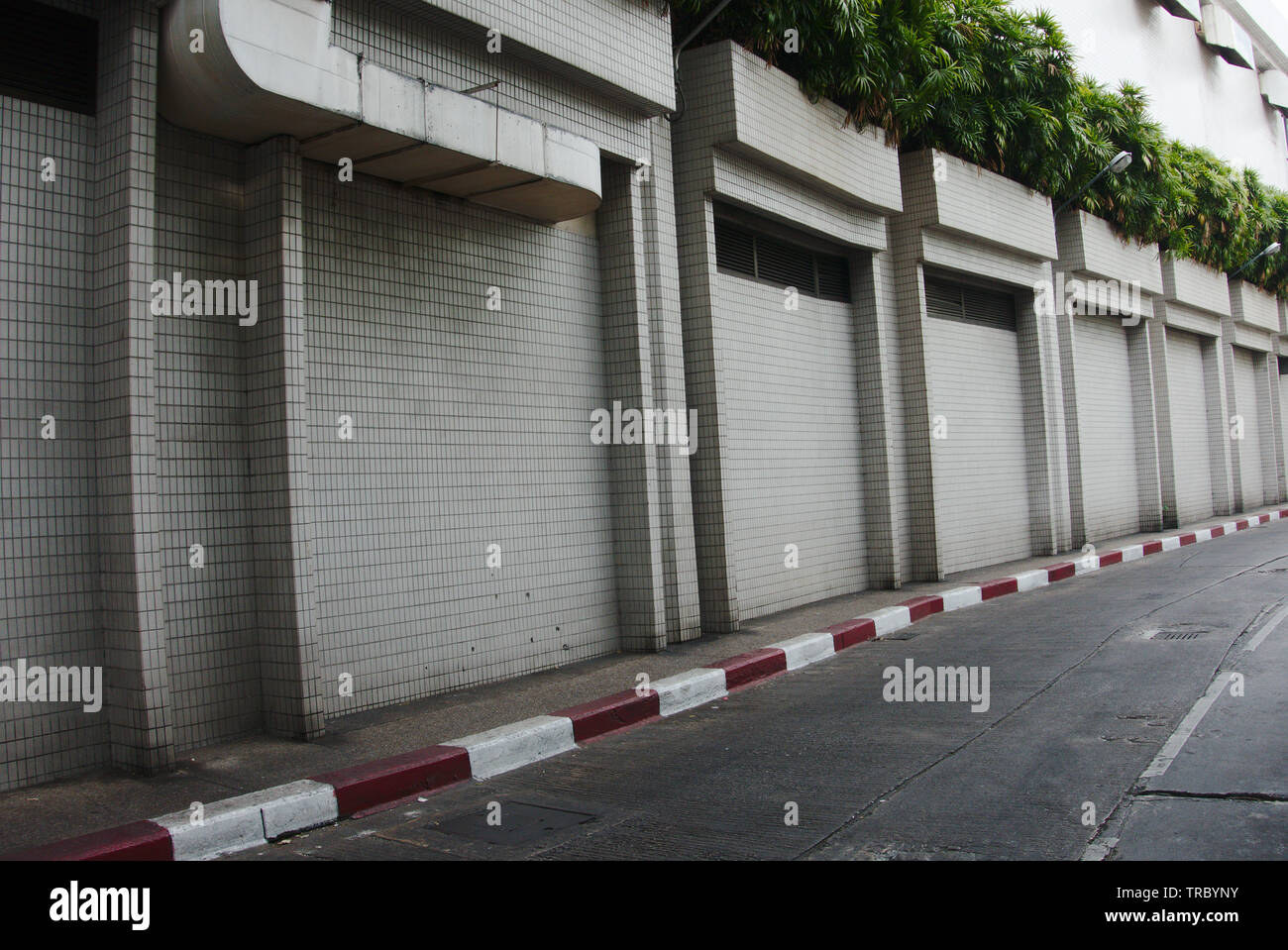 Old grey block wall and cement road in alley Stock Photo - Alamy