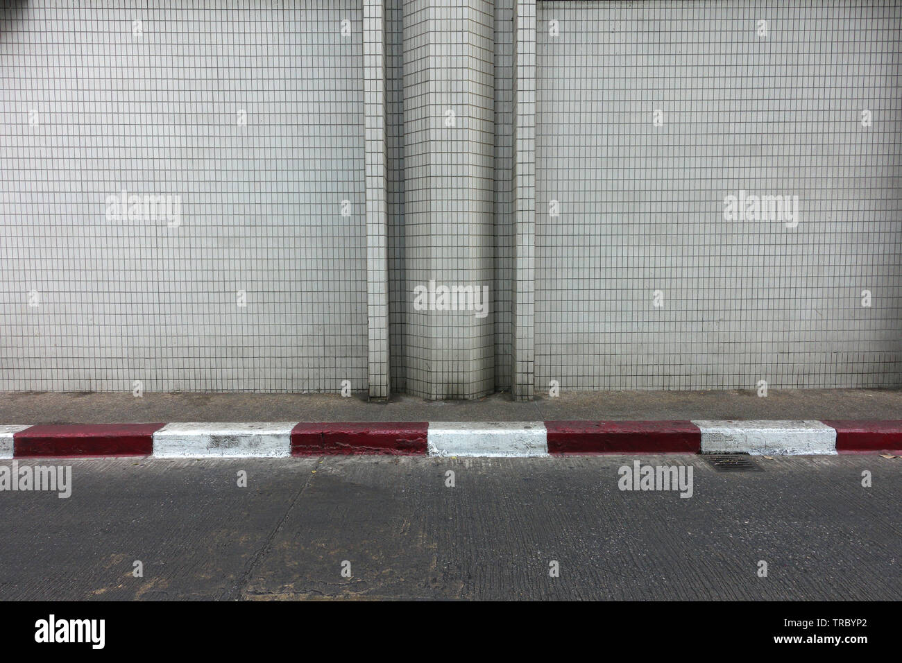 Old grey block wall and cement road in alley Stock Photo - Alamy