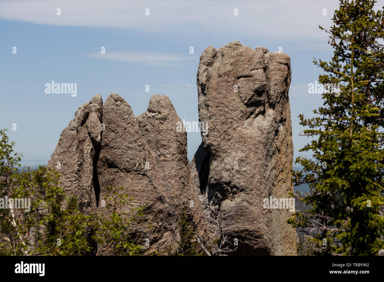 Enormous rock formations against a blue sky in the Cathedral Spires ...