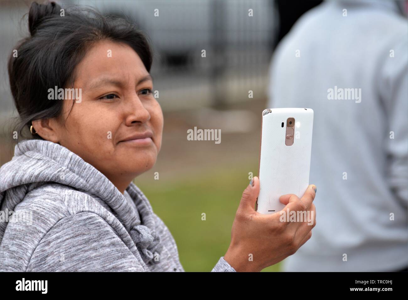 Latina women on phone talking photos photo pictures and videoing family ...