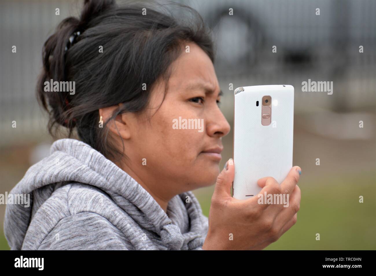 Latina women on phone talking photos photo pictures and videoing family ...