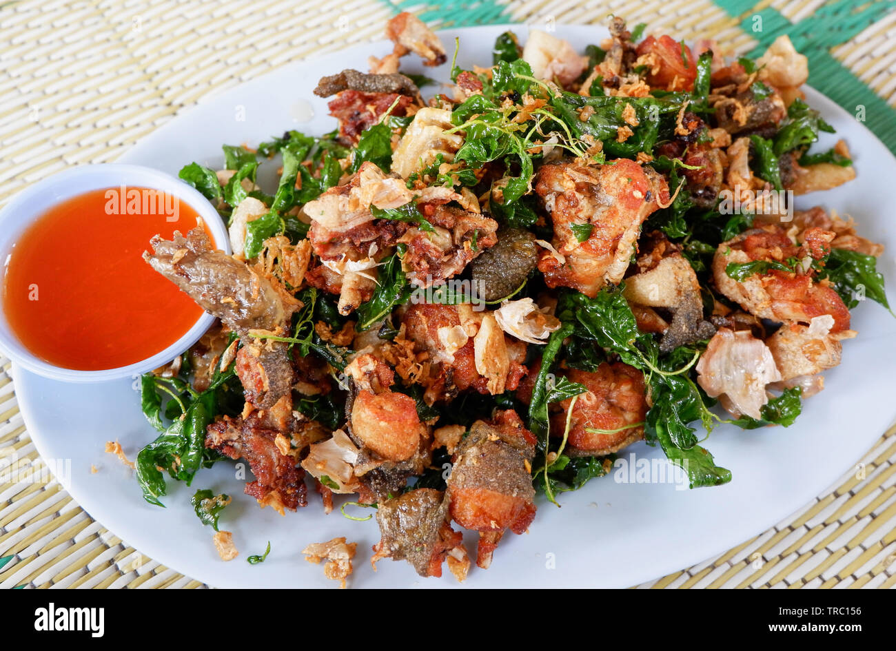 Fried Frog crispy with herb and spices garlic holy basil on plate Stock ...