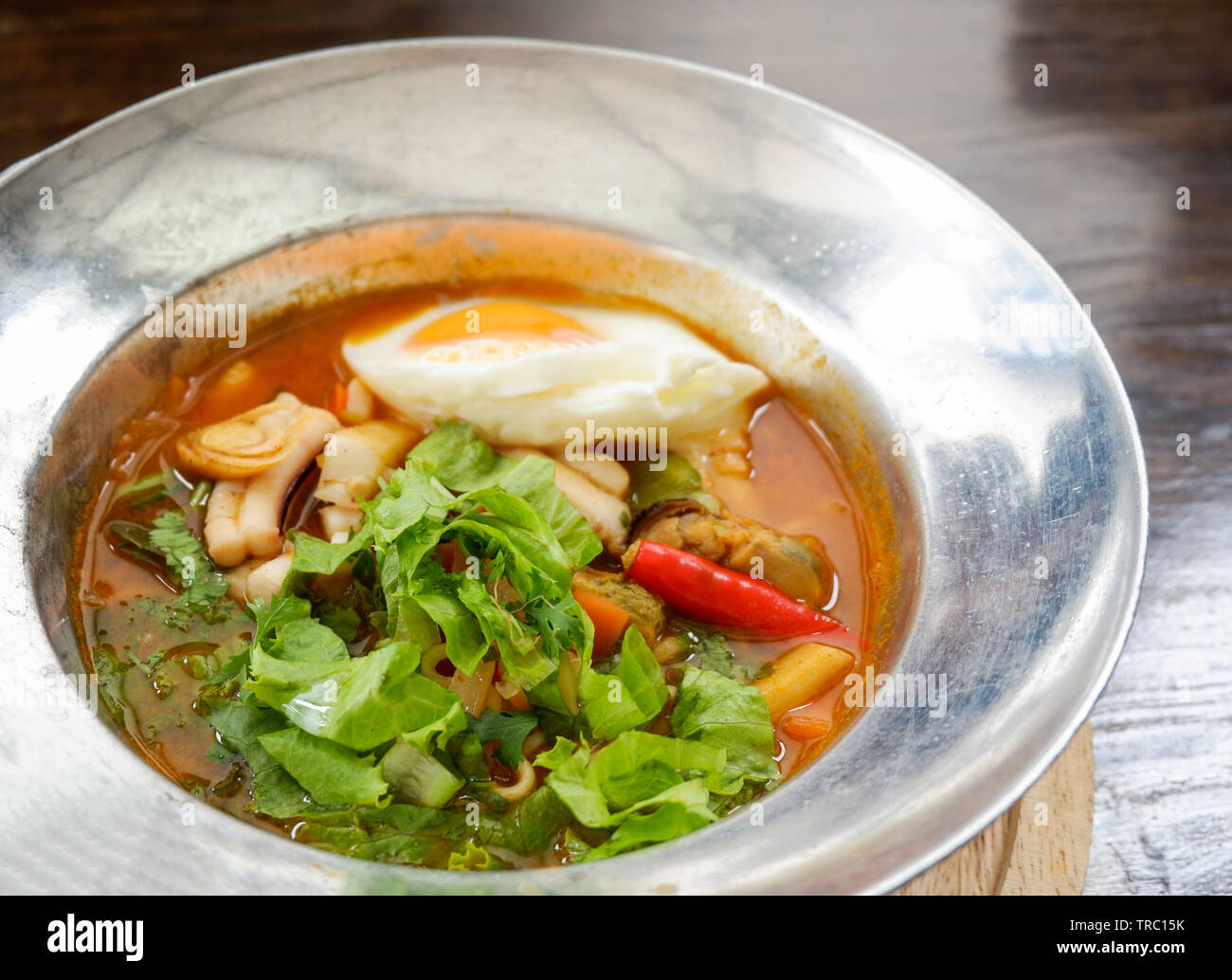 Sour soup with seafood shrimp squid / Hot soup fish mussel egg and ...