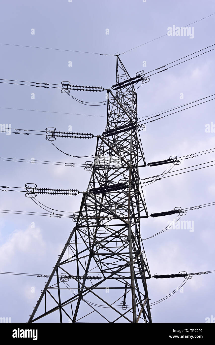 High voltage power cables are hanging over blue sky from electric pole ...