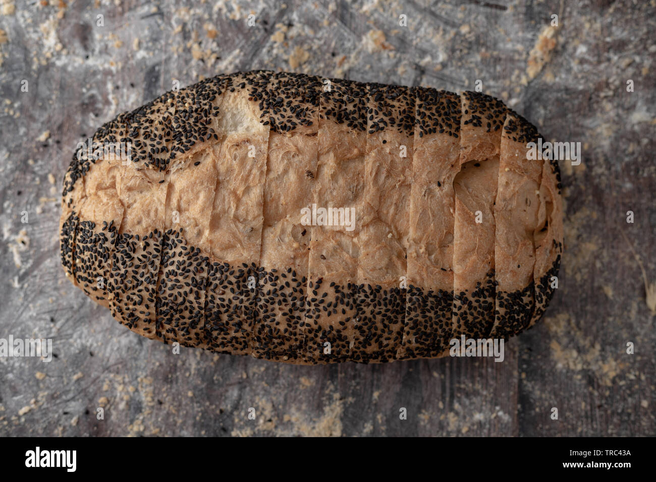 Gold corn bread loaf on the wooden table with crumbs and pastry flour ...