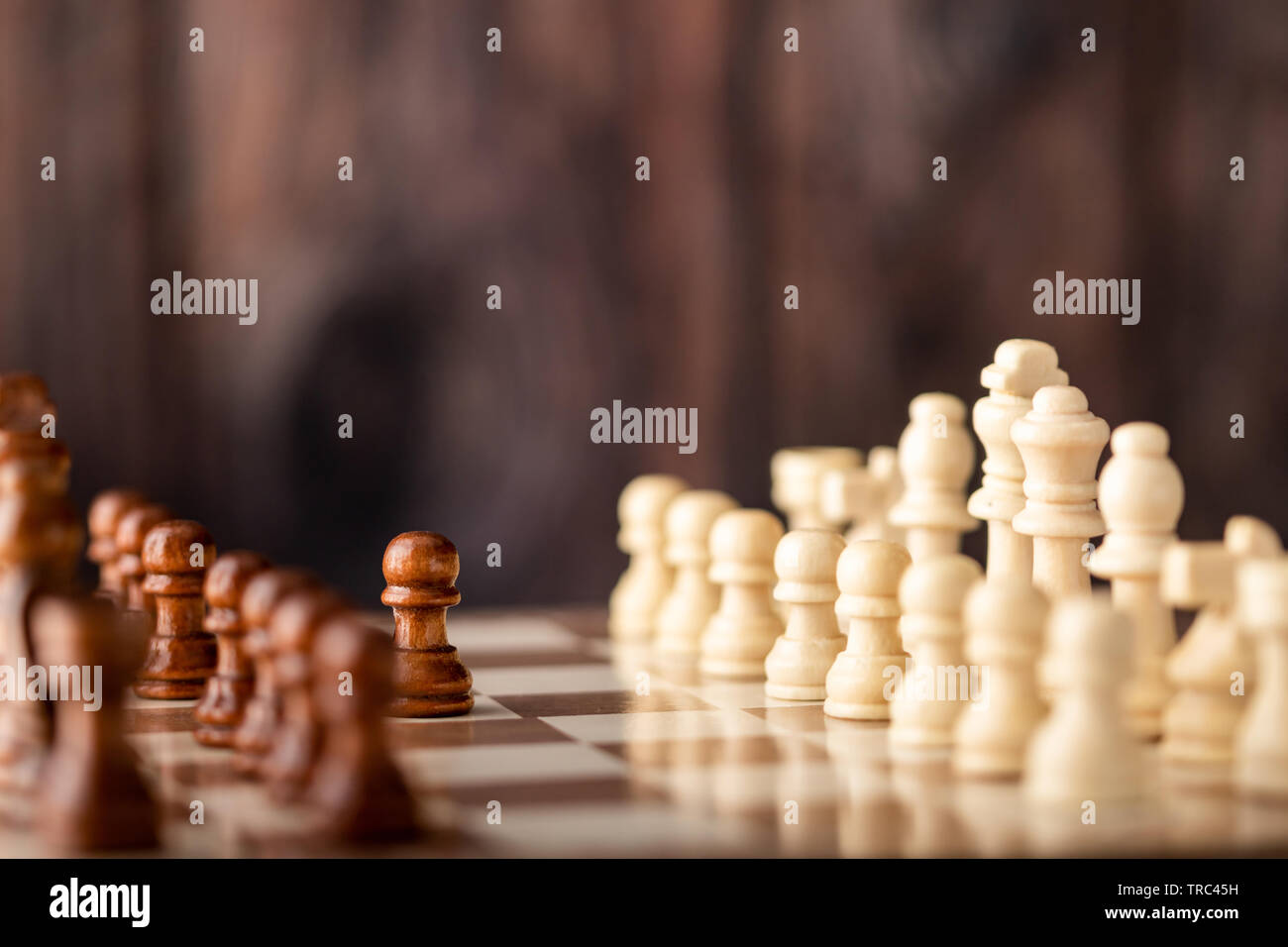 wooden chess endways on the board with wood background. Select focus ...