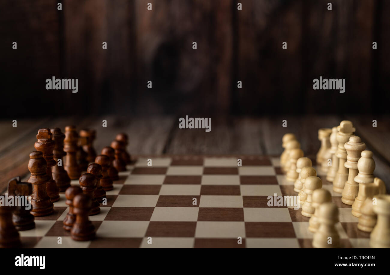 wooden chess endways on the board with wood background. Select focus ...