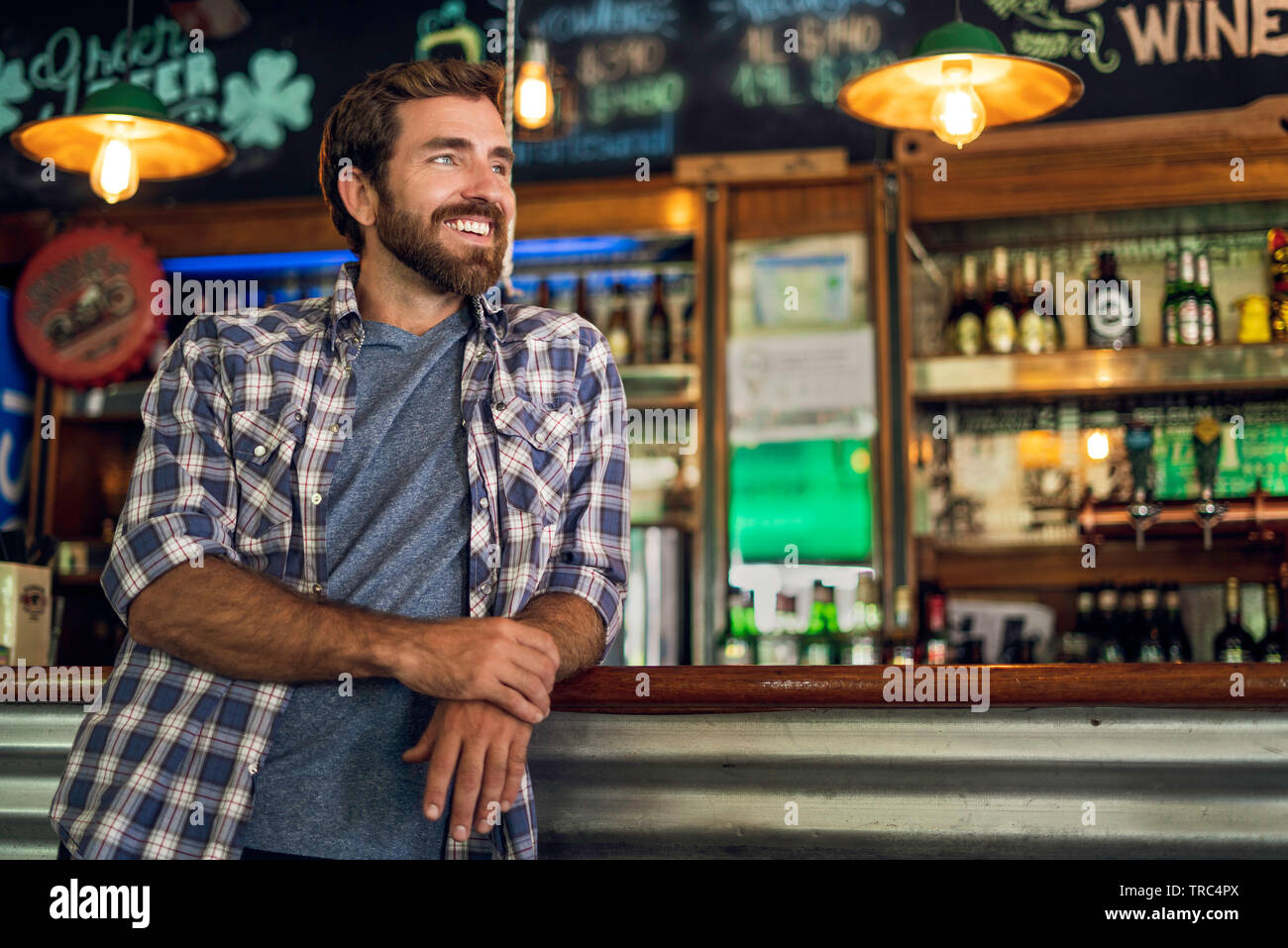 Man leaning against bar counter Stock Photo - Alamy