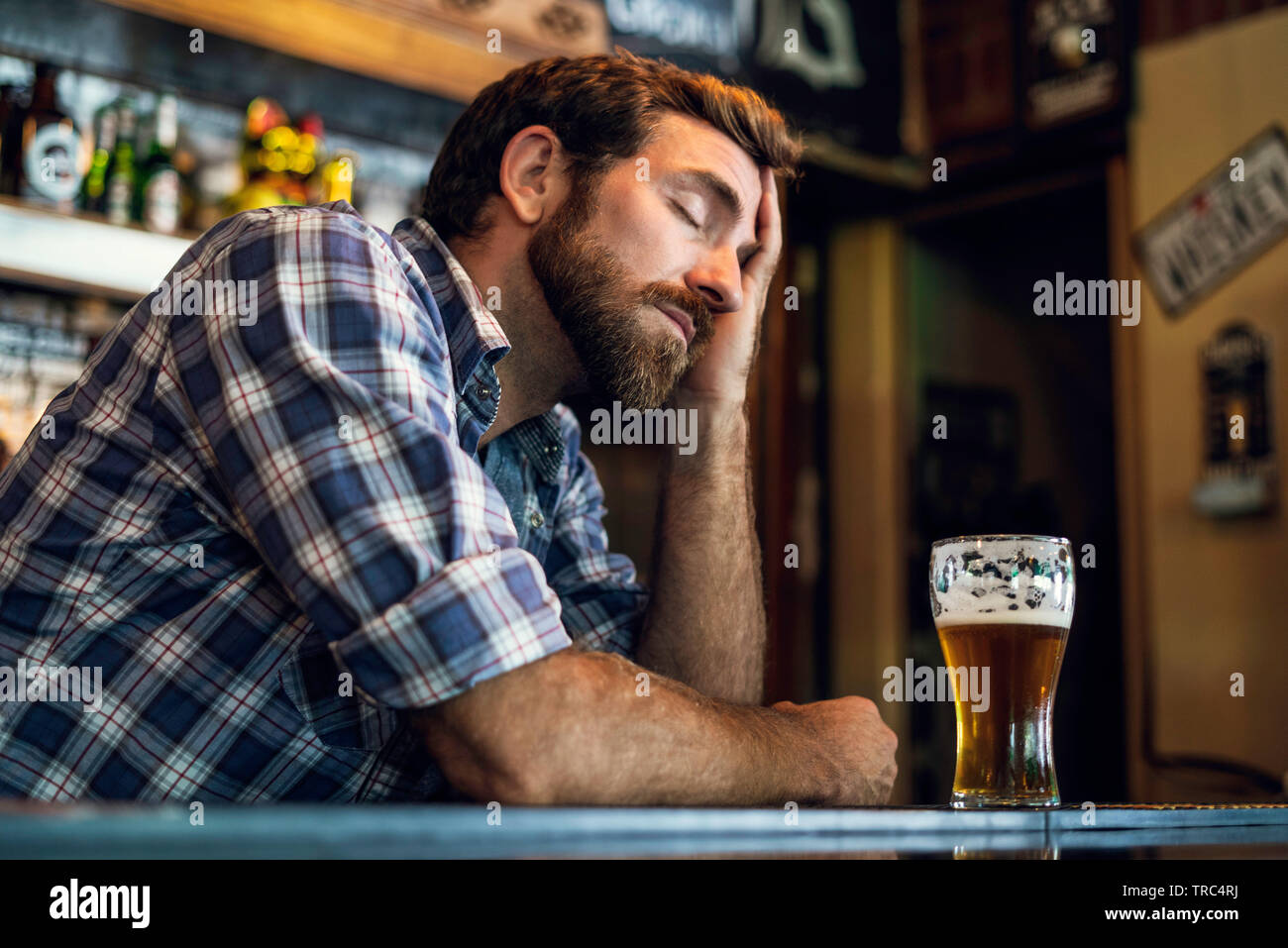 Sad man sitting in beer bar Stock Photo - Alamy