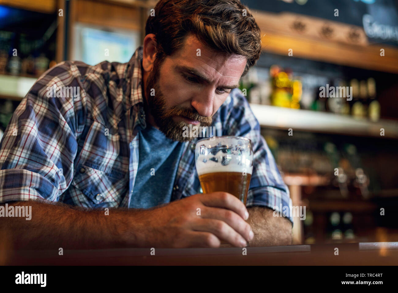 Man Drinking Beer At Bar