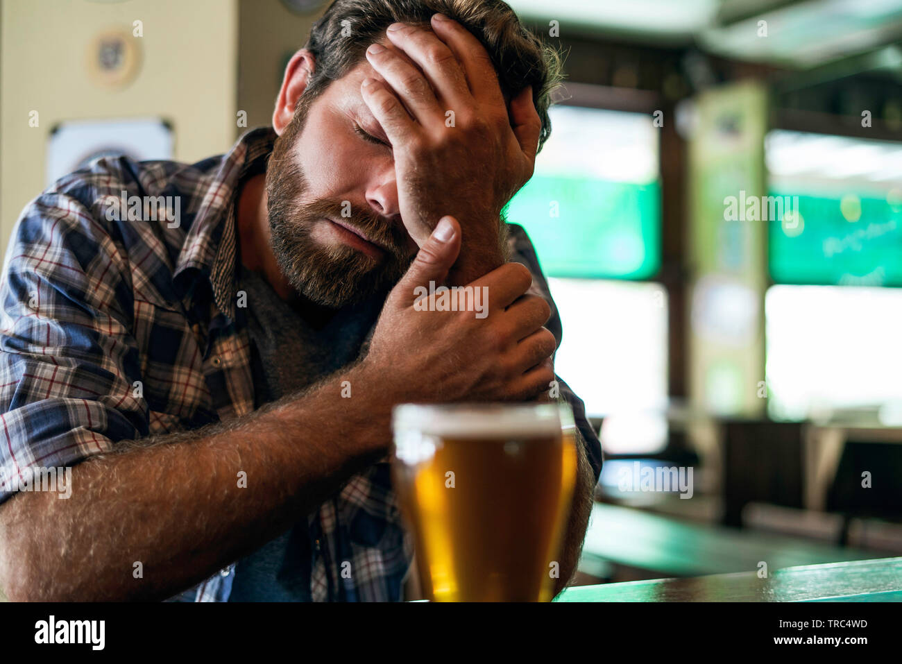 Sad man sitting in bar Stock Photo - Alamy