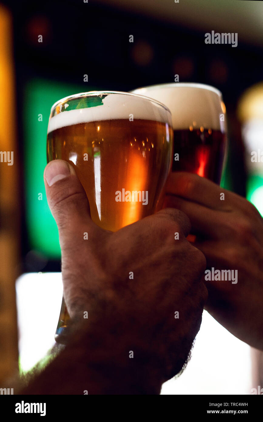 Hands toasting beer glasses Stock Photo - Alamy