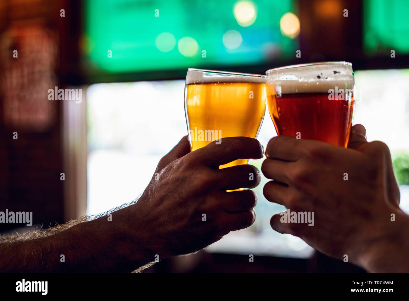 Hands toasting beer glasses Stock Photo - Alamy